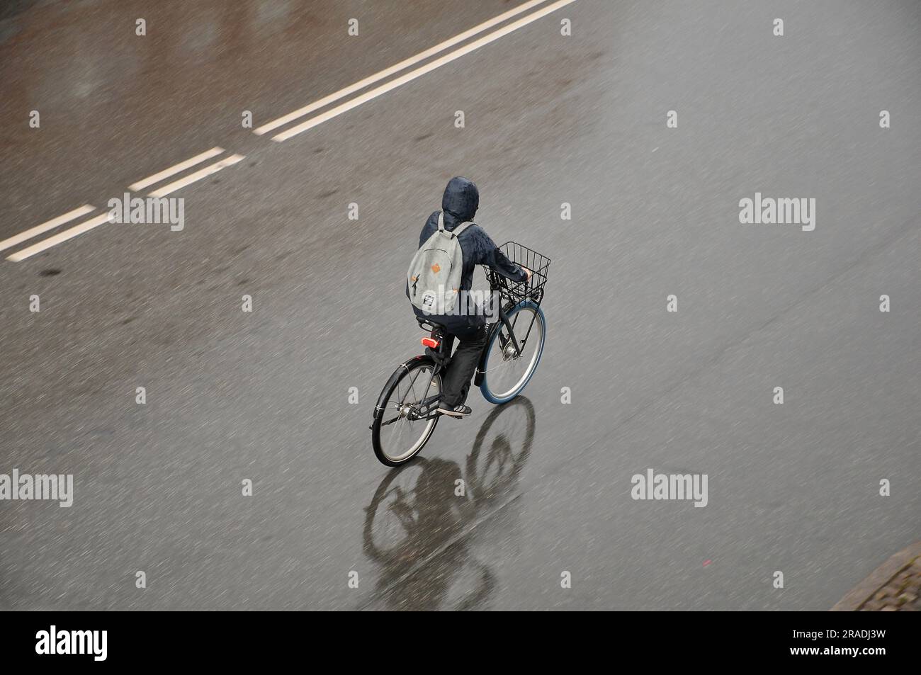 03 July 2023/ Person bike in rain fall in Kastrup danish capital ...