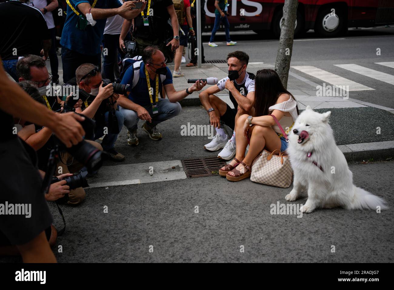 Britain's Adam Yates, left, is interviewed as he sits next to his ...