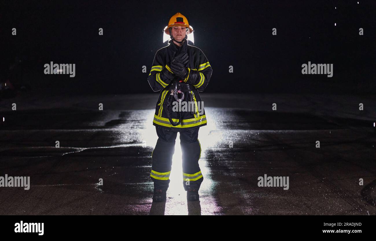 Portrait of a female firefighter standing and walking brave and ...