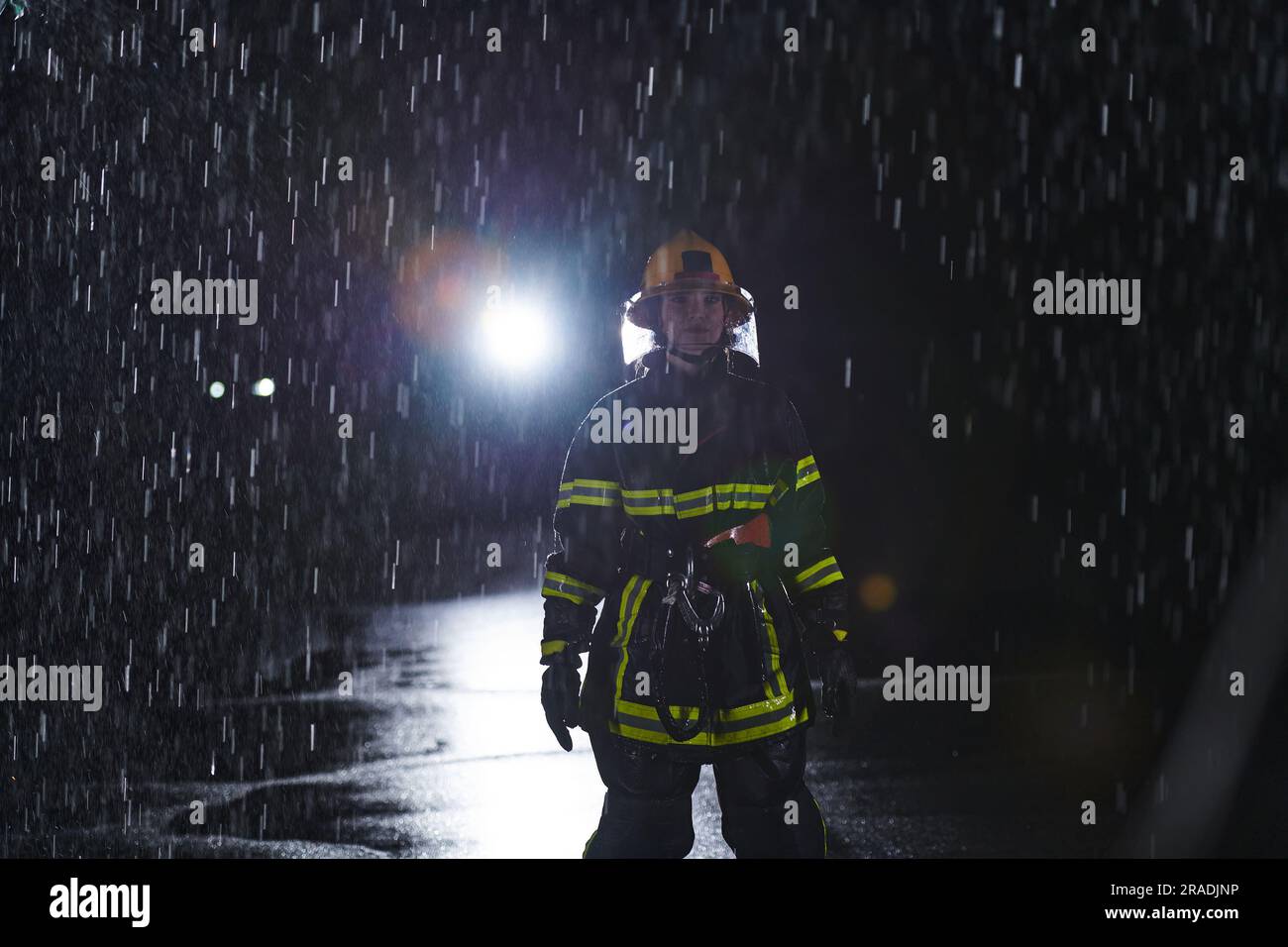 A determined female firefighter in a professional uniform striding ...