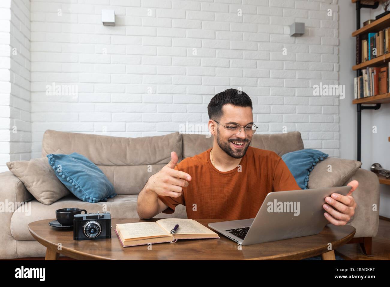 Young smart intelligent student man sitting at home on floor working as ...