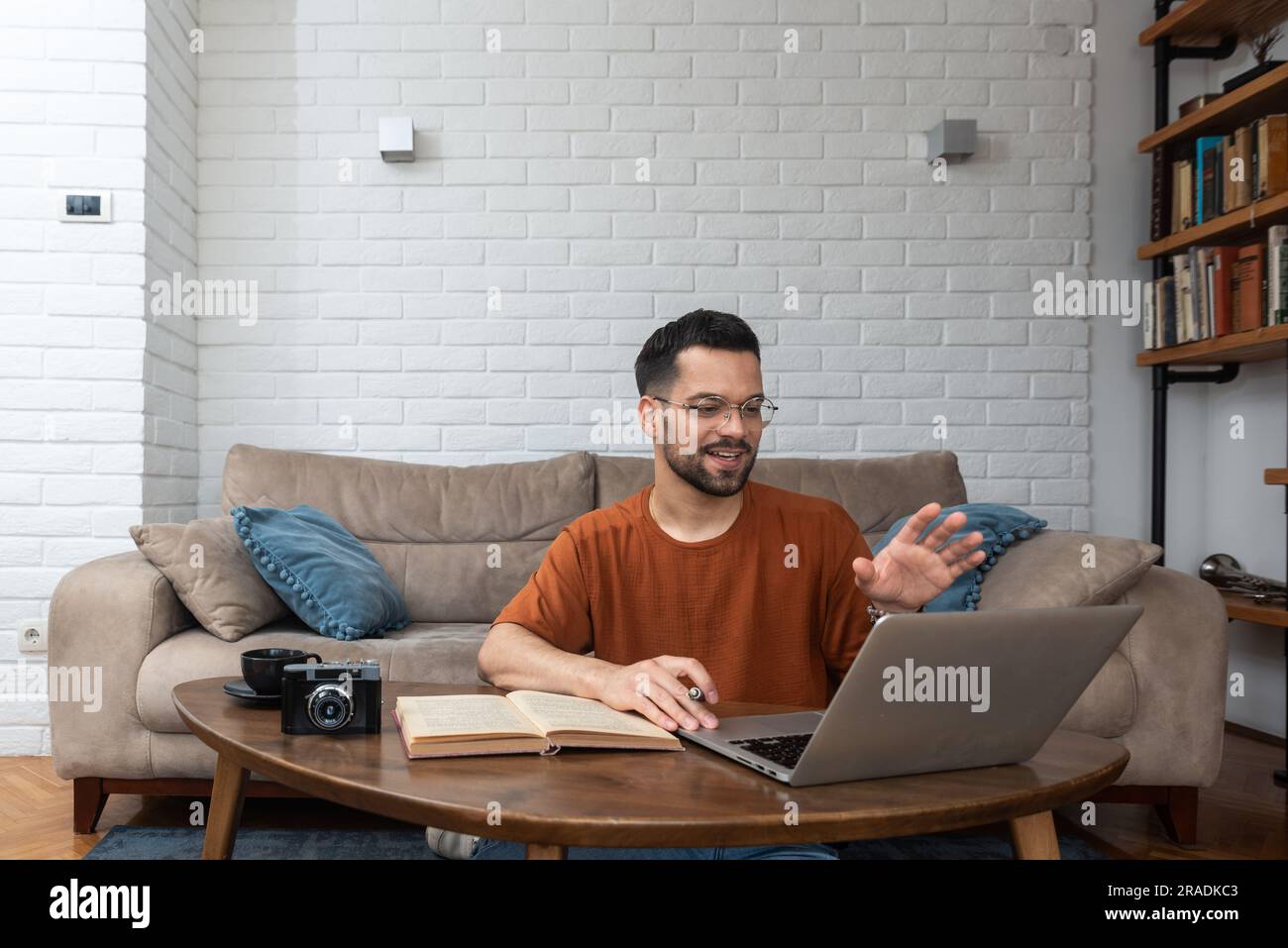Young smart intelligent student man sitting at home on floor working as ...