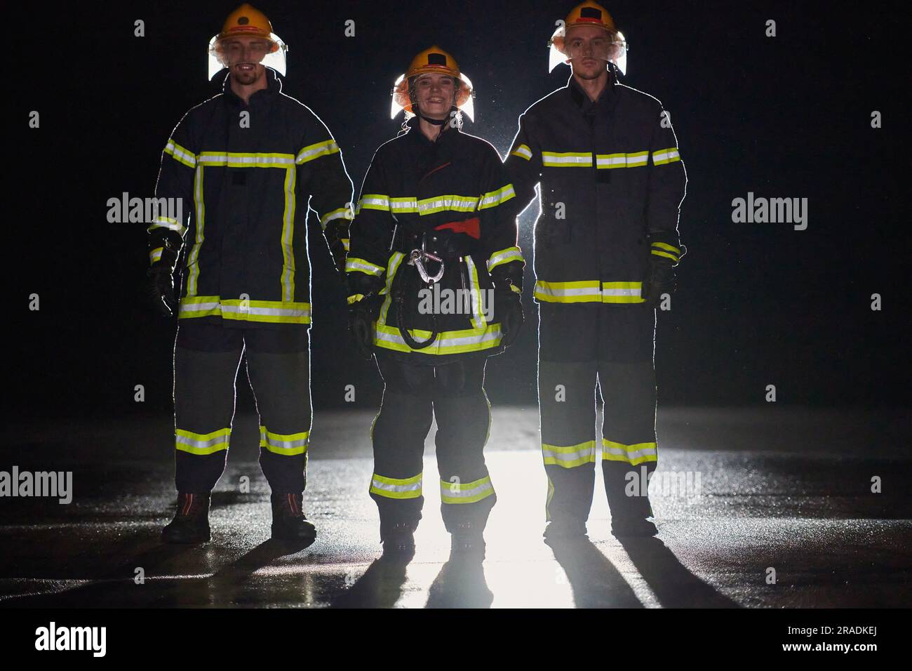 A group of professional firefighters marching through night on a rescue ...
