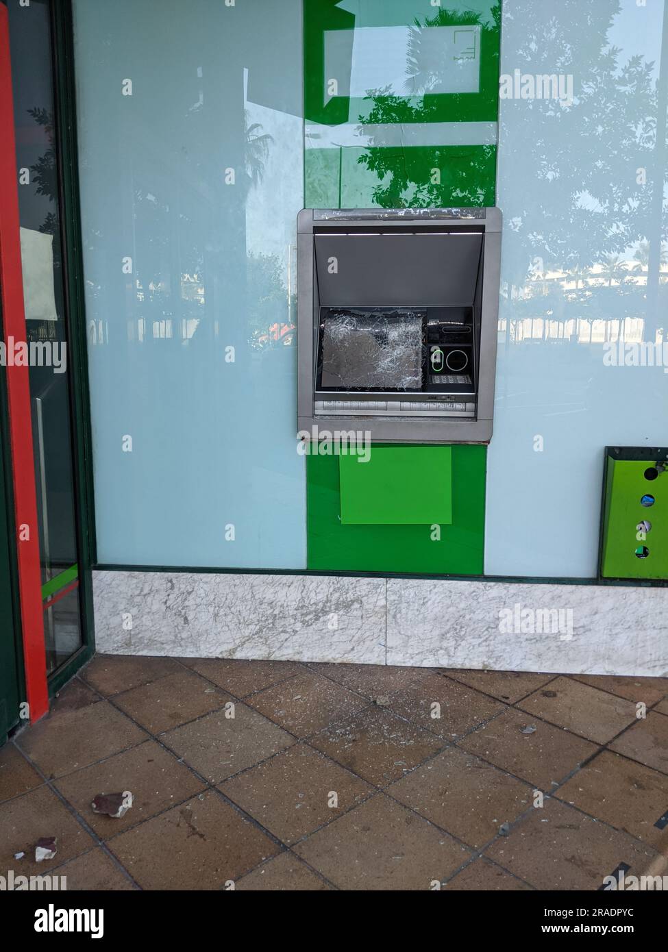 Broken glass of red bank ATM, vertical Stock Photo - Alamy