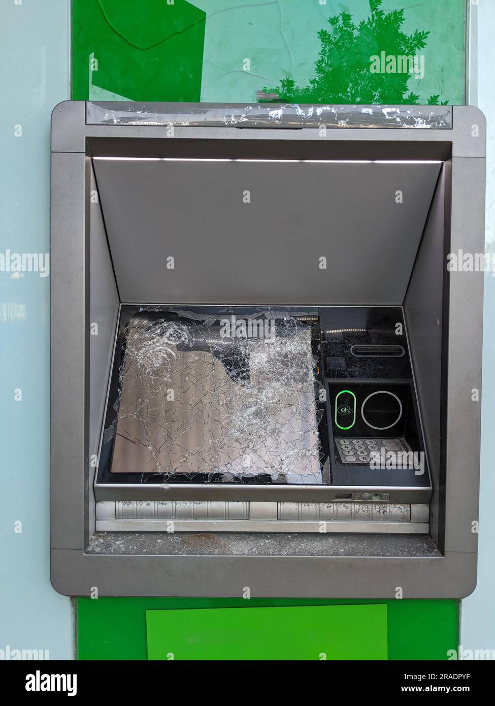 Broken glass of red bank ATM, vertical Stock Photo - Alamy