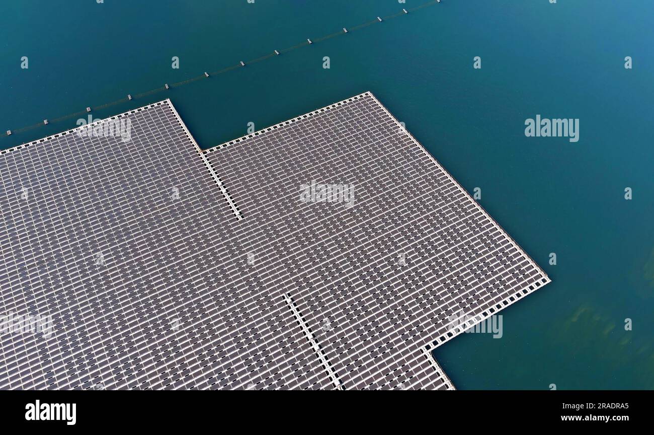 Aerial view showcases expansive array of solar panels, creating ...