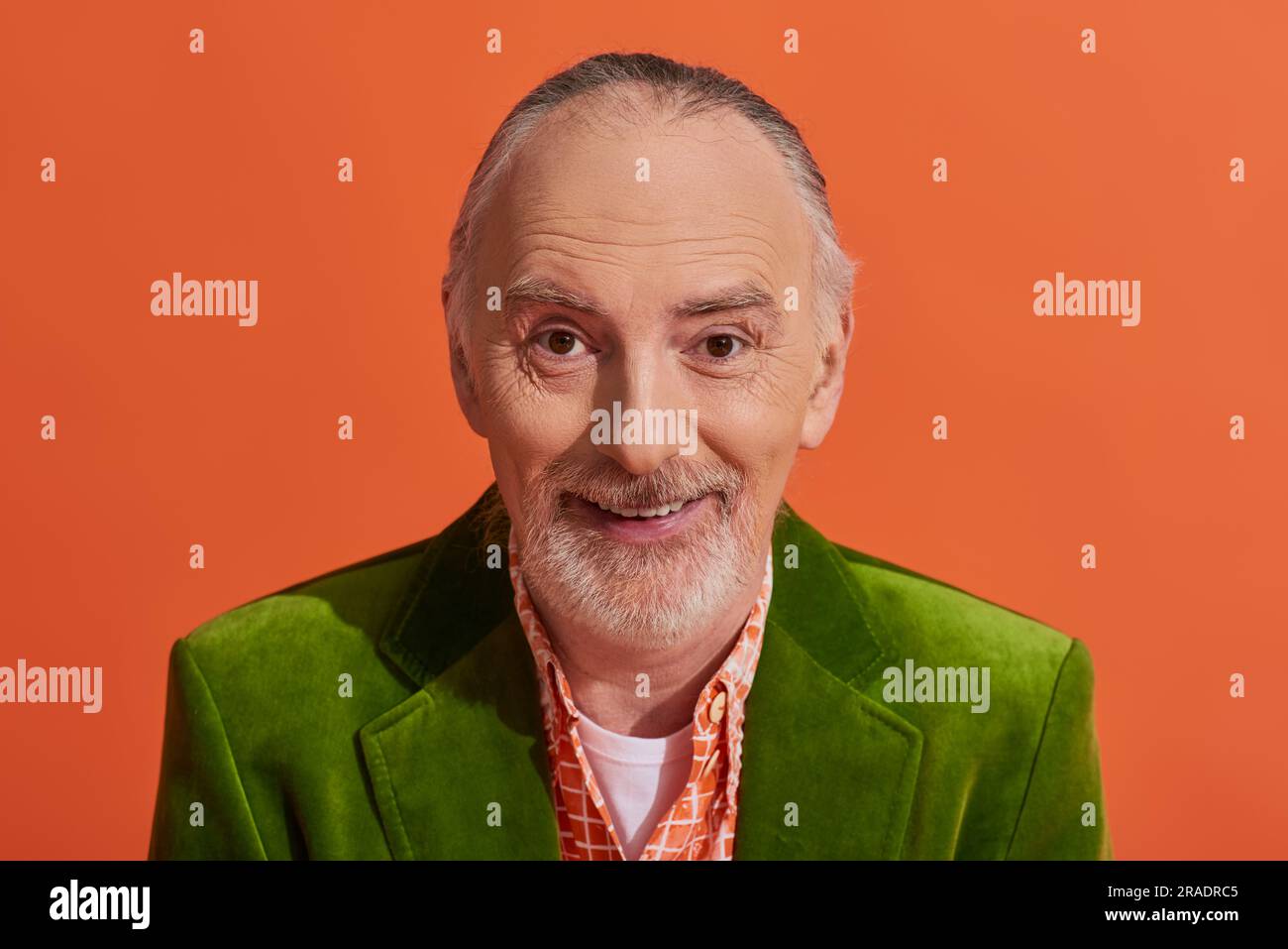 portrait of charismatic senior male model with grey hair, beard and ...