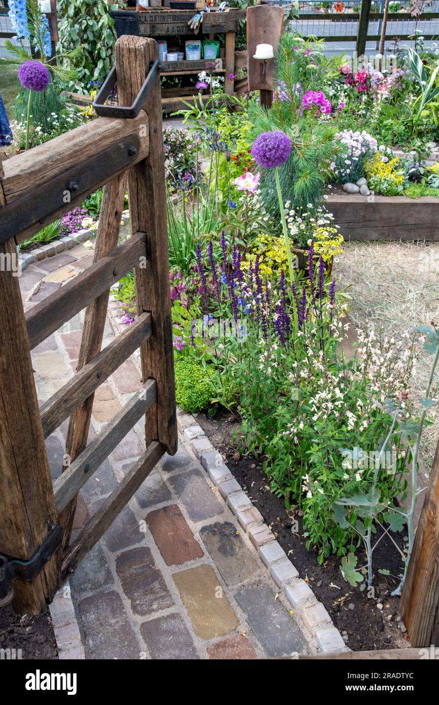 Wooden gate, garden arrangments, and floral displays Stock Photo - Alamy