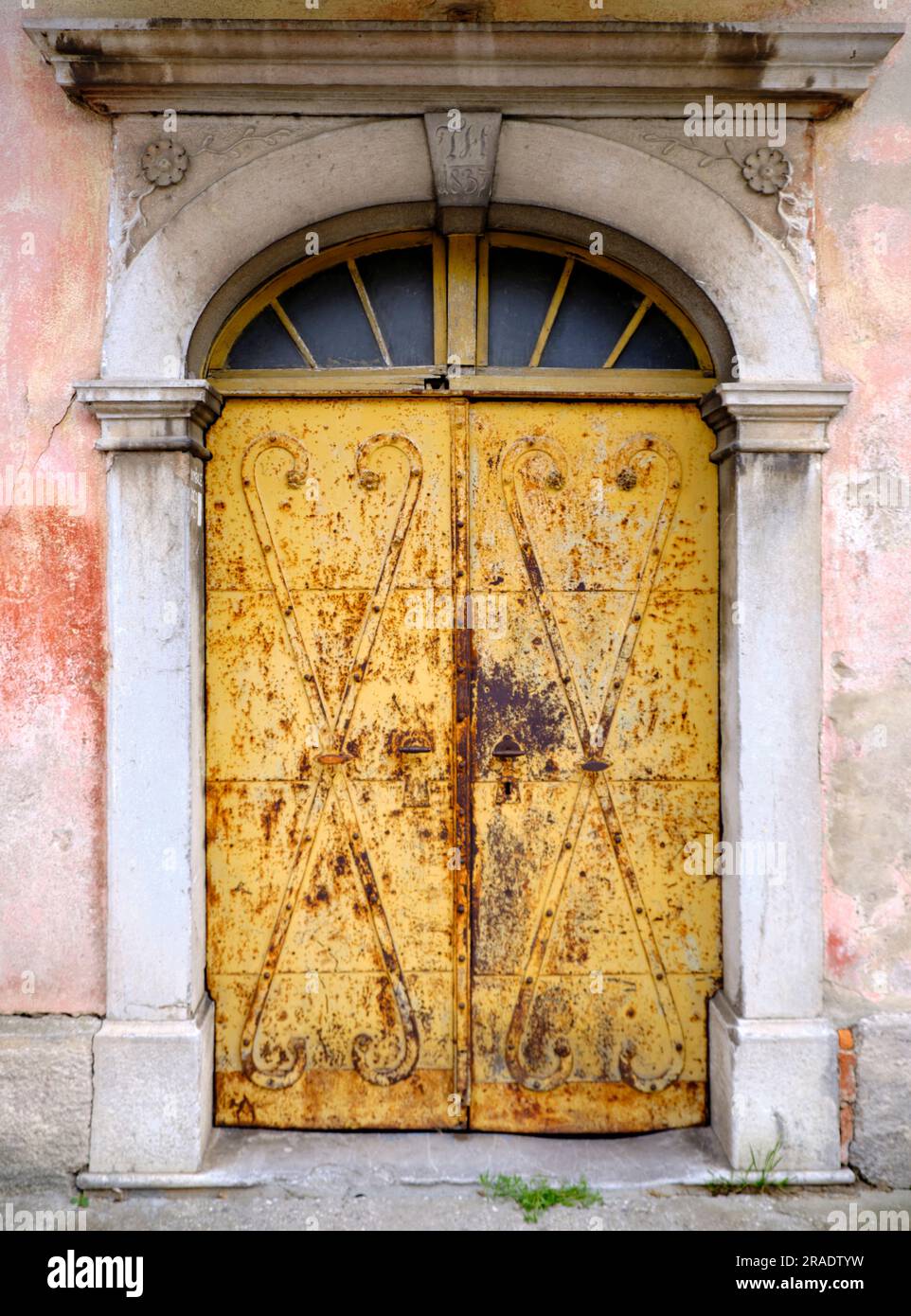 Old vintage 19th century yellow metal door, with large spots of rust ...