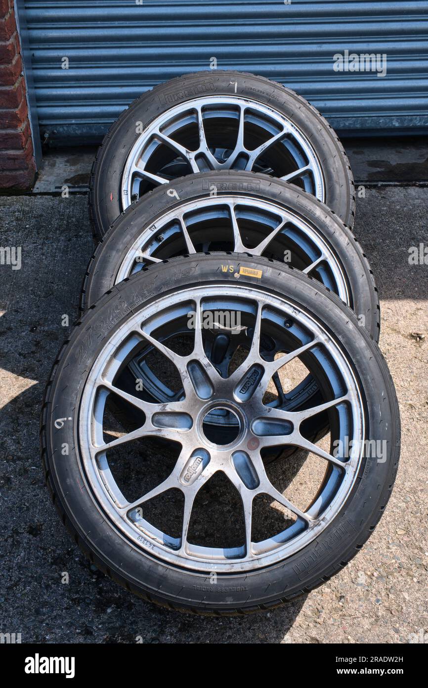 Three wheels for a Ferrari Challenge Evo racing car stacked in the ...