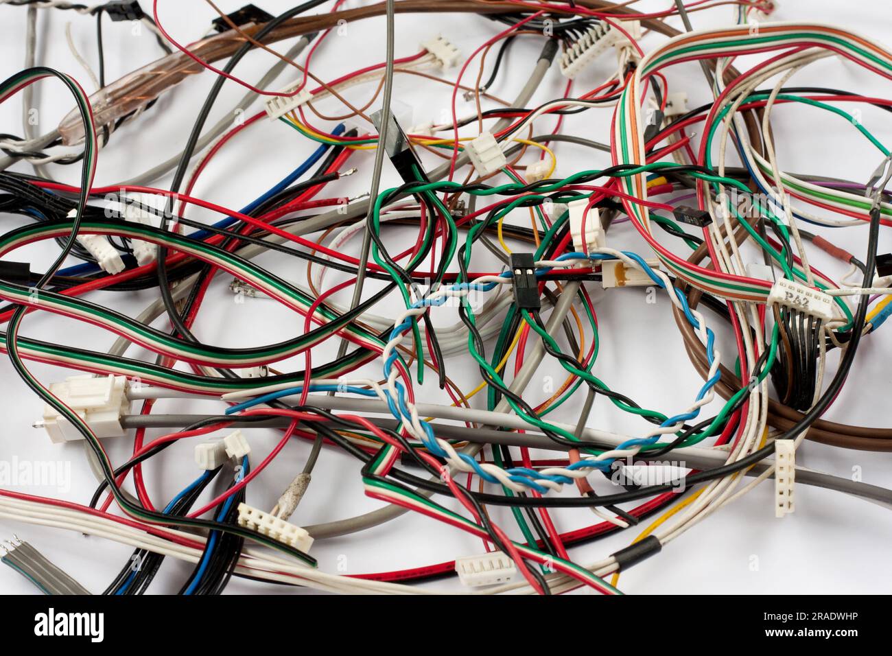 Colored cables and wires with connectors on white background. Chaos of ...
