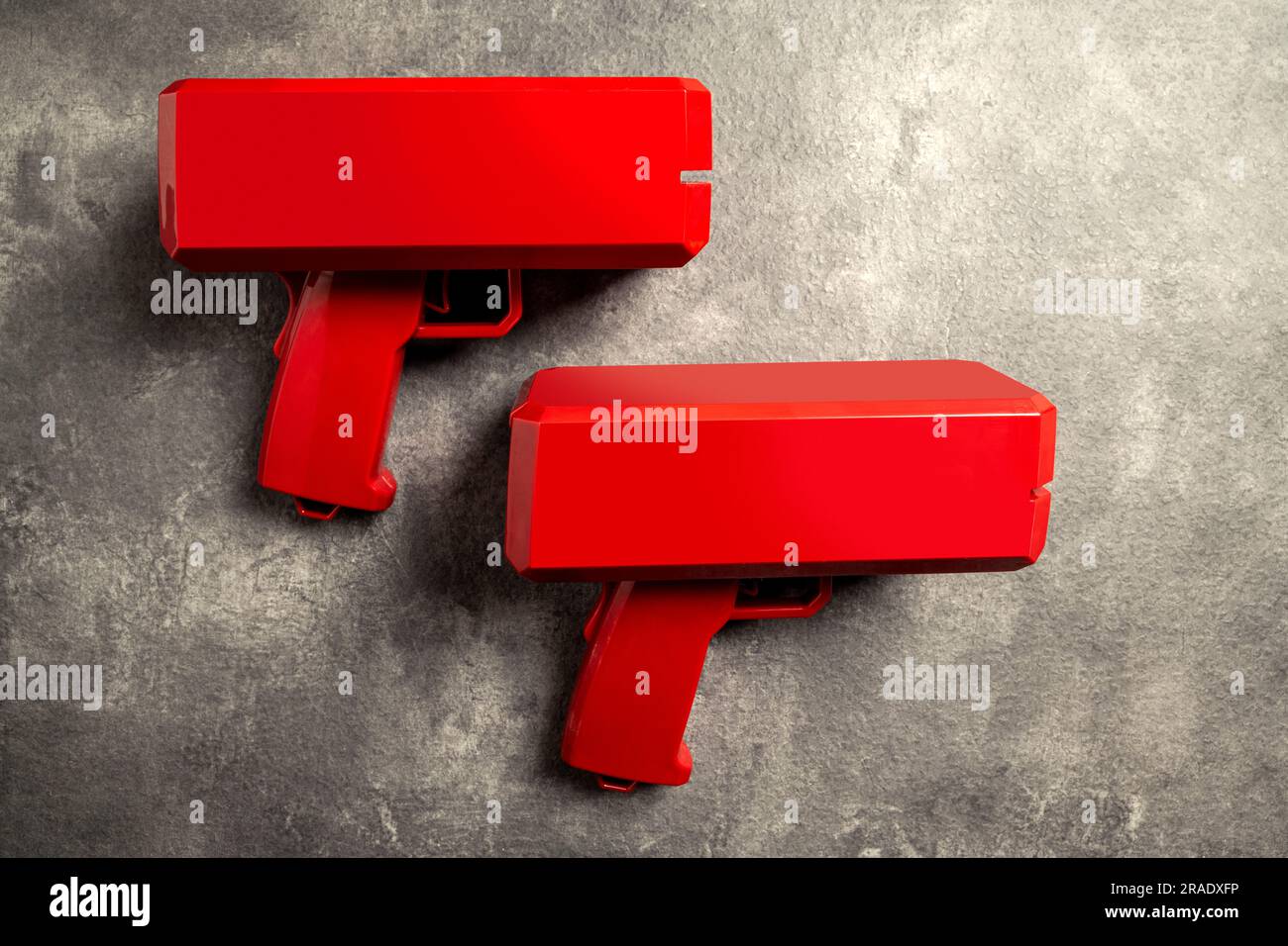 Red money gun on black background Stock Photo - Alamy
