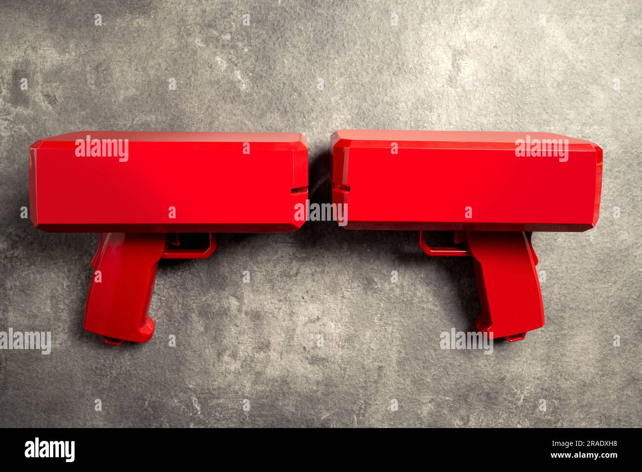 Red money gun on black background Stock Photo - Alamy