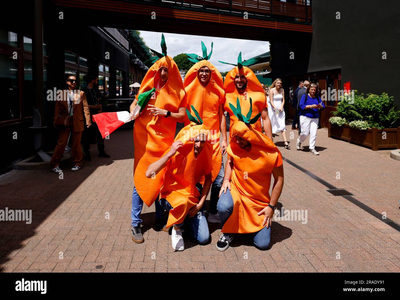 Spectators dressed as carrots, who are supporting Jannik Sinner, on day ...
