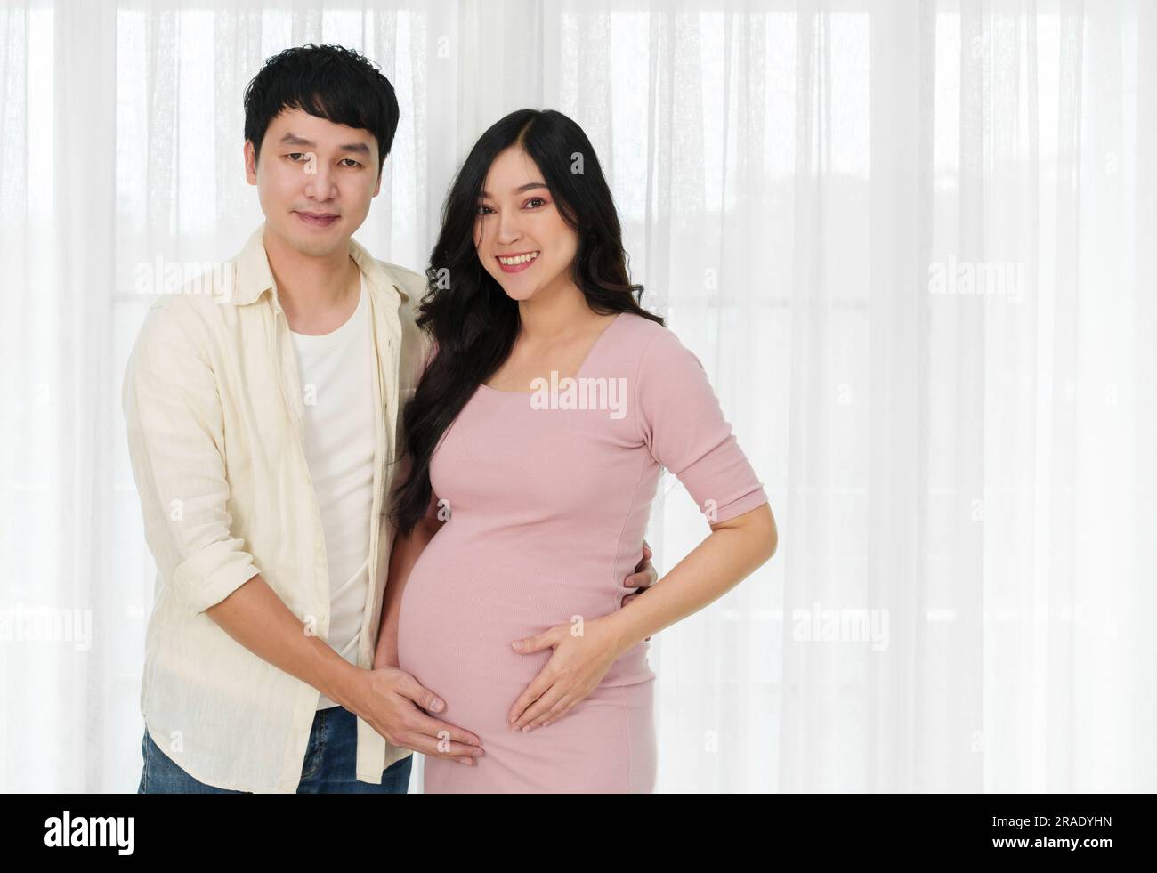 married couple is expecting baby. man embraces his pregnant wife on a ...