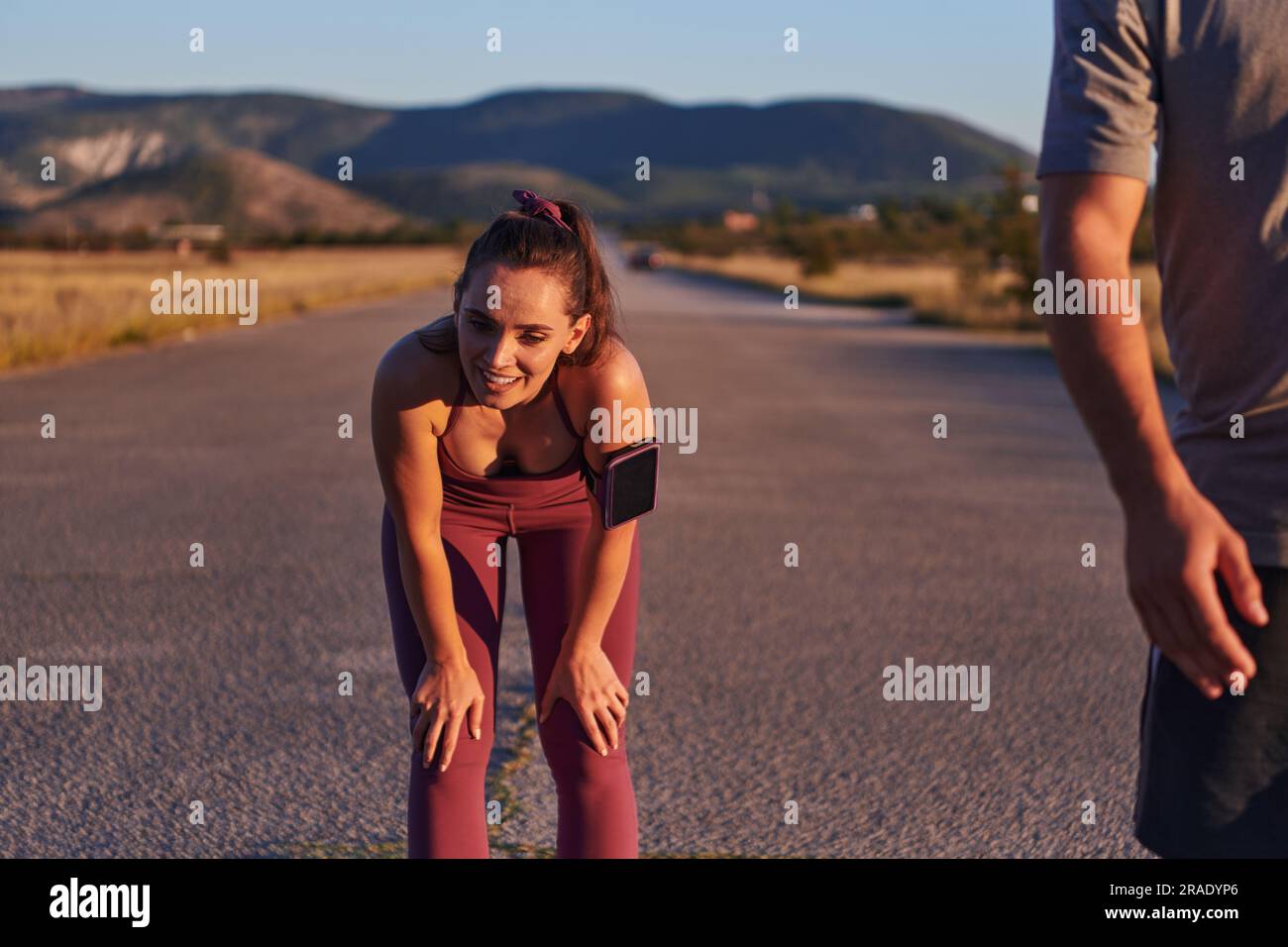 A couple resting after a rigorous morning run, embracing the ...