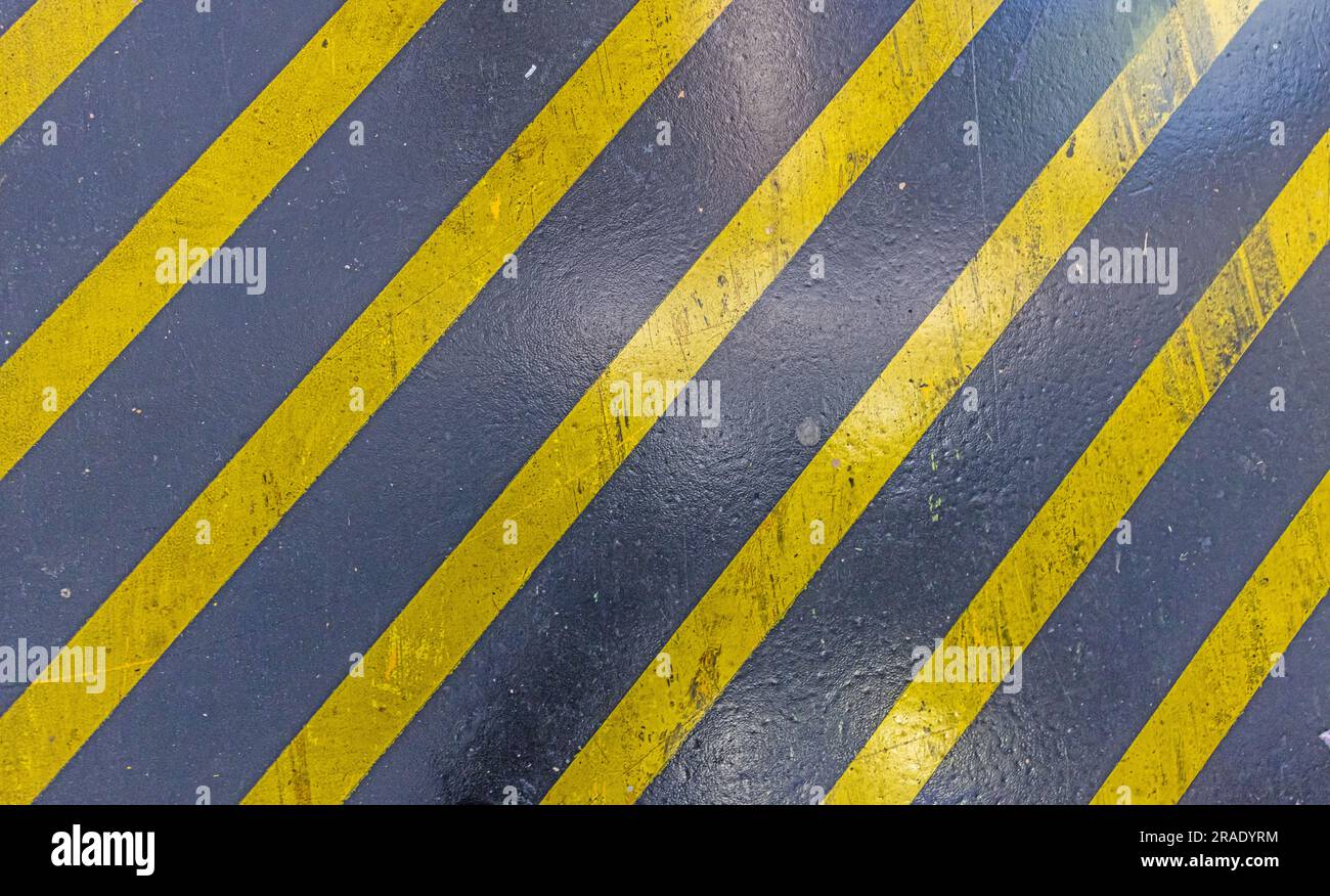 Vertical shot on a black ground surface with yellow hatching as a ...
