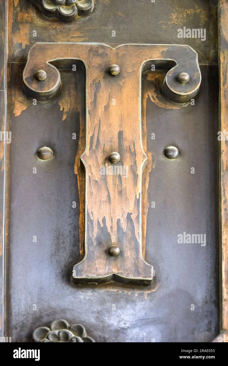 Metal alphabet letter T on an old iron background. Close-up. Copy space ...