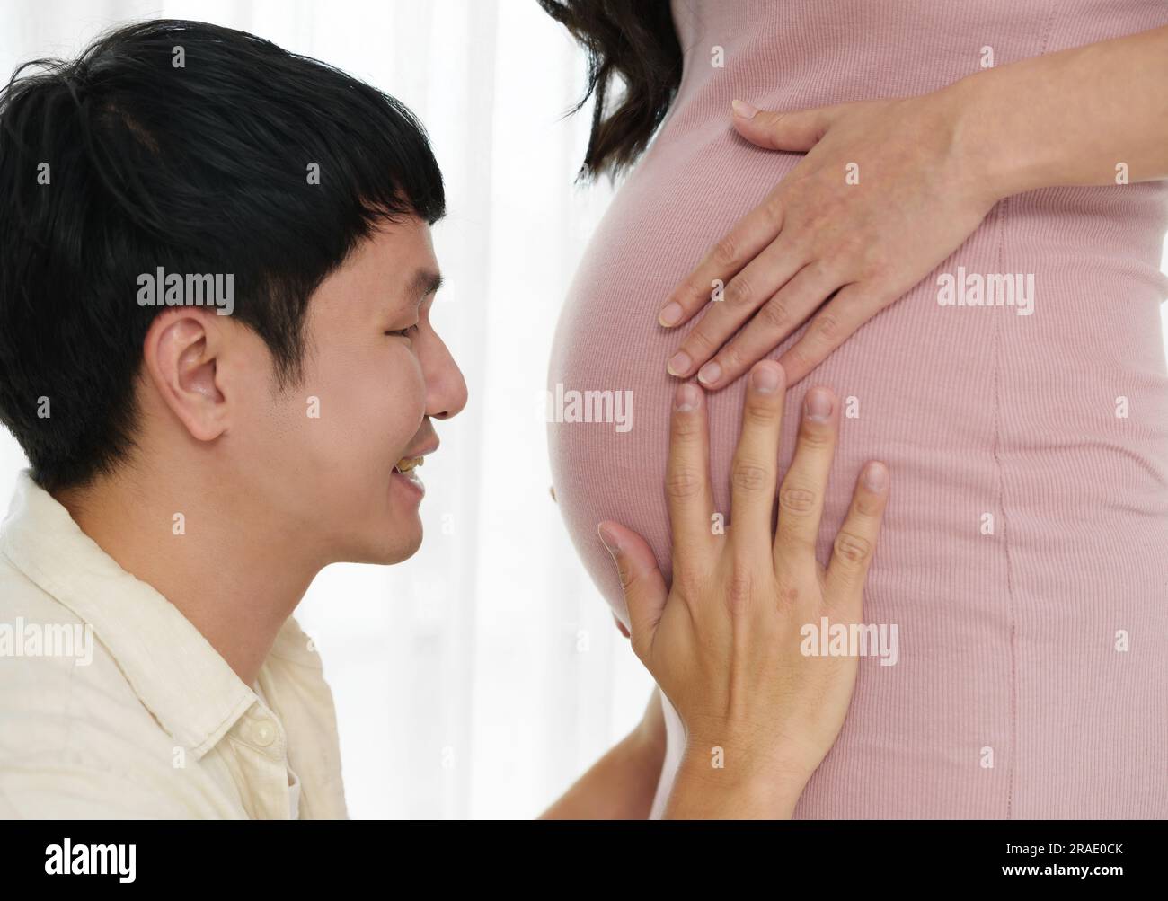 close up husband talking with baby in his wife belly Stock Photo - Alamy