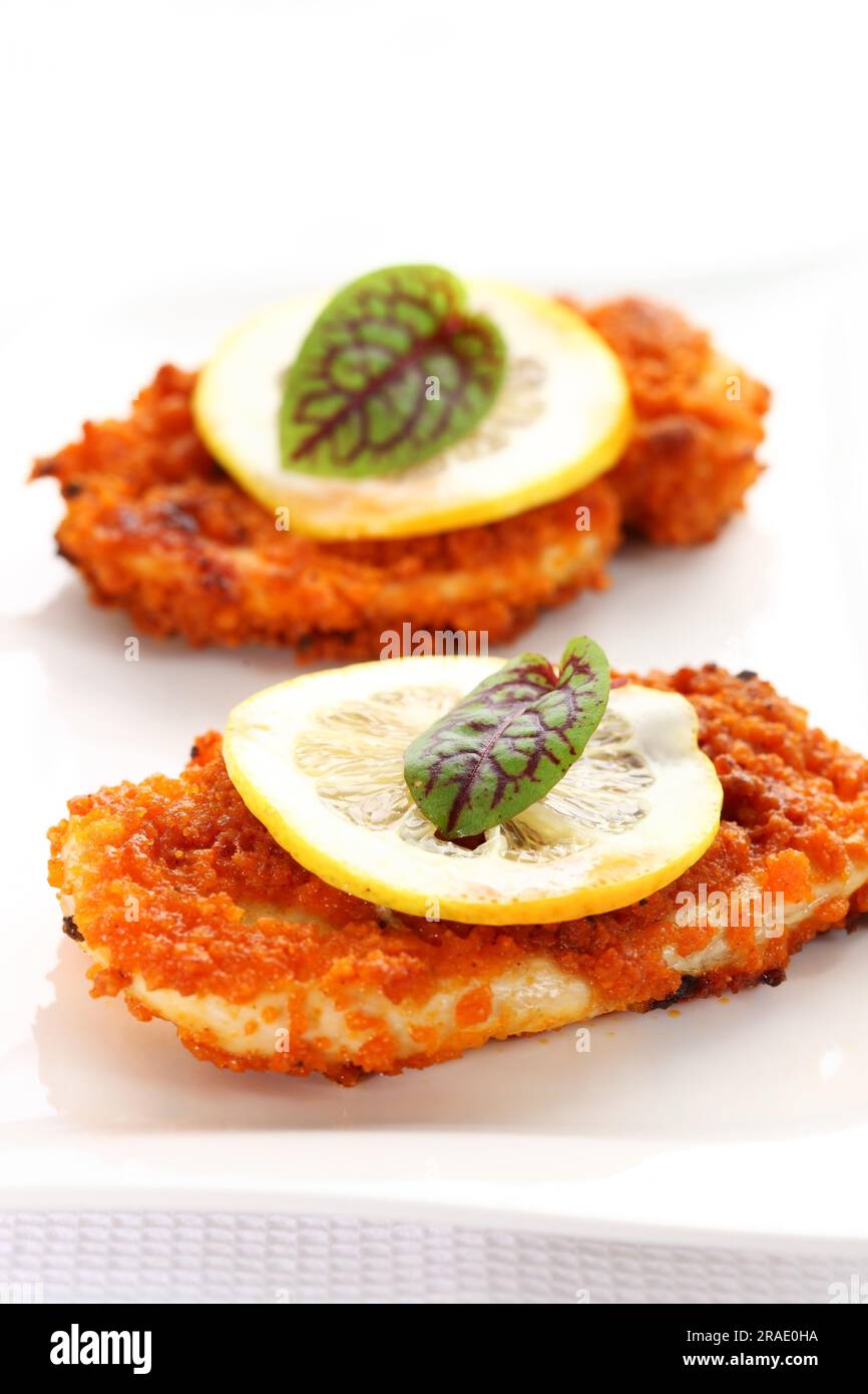 Breaded chicken schnitzel with lemon Stock Photo - Alamy