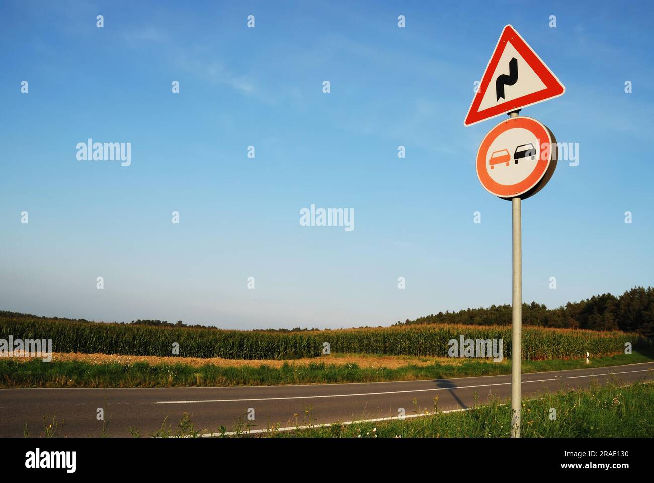 Landscape with a traffic sign: Don't overtake because of curves Stock ...