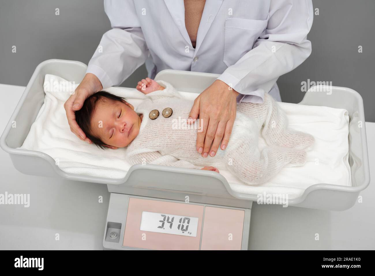 newborn baby weight measurement on the digital scales with doctor in hospital Stock Photo - Alamy
