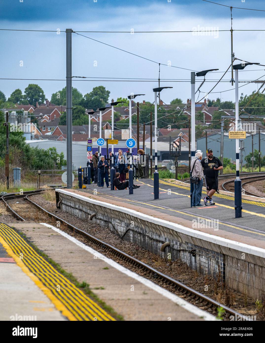 Passengers and travellers stood waiting for a train at Grantham Station ...