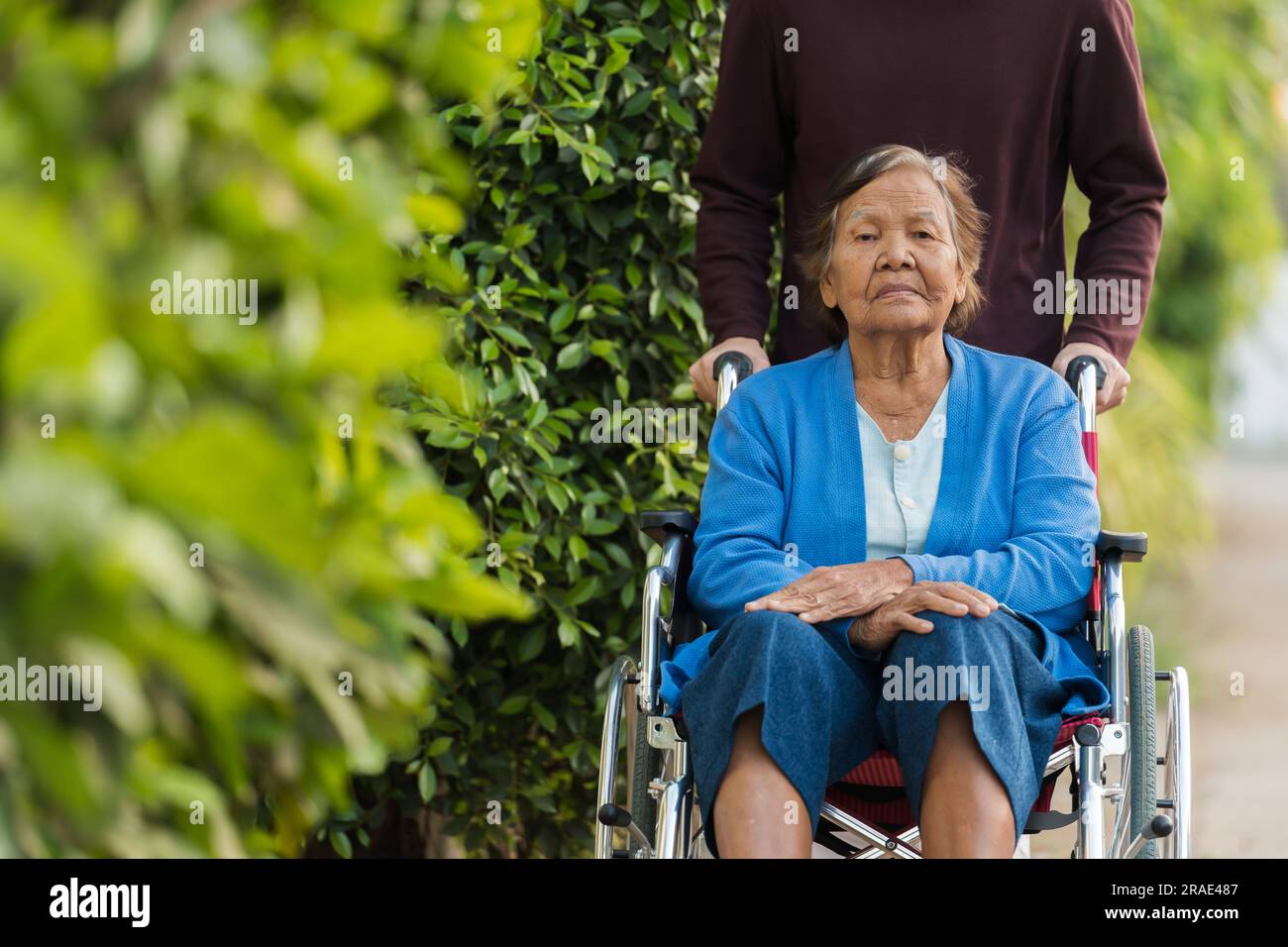 Man pushing old woman in hi-res stock photography and images - Alamy