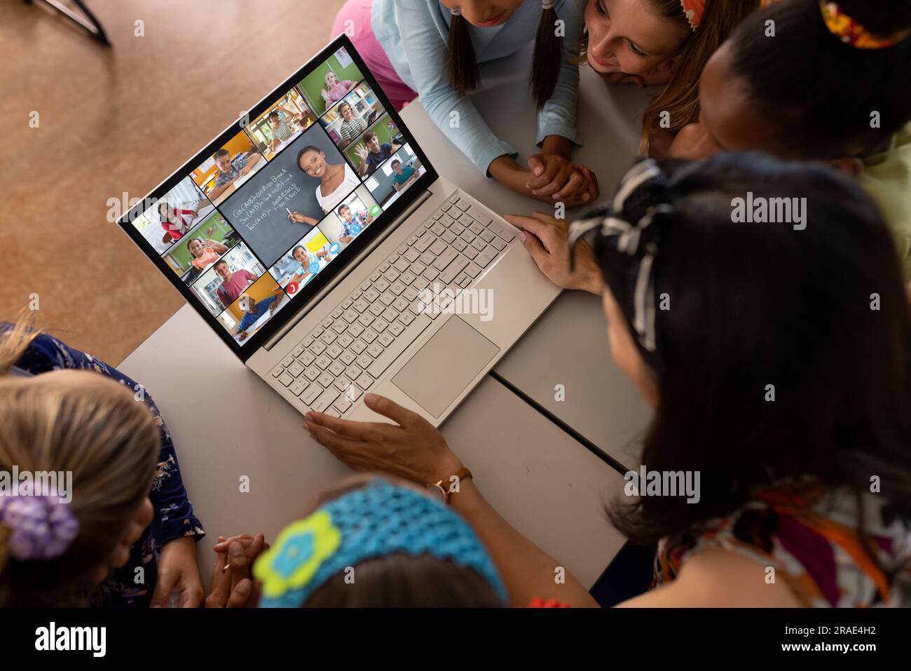 Diverse schoolchildren with female teachers having laptop video call in ...