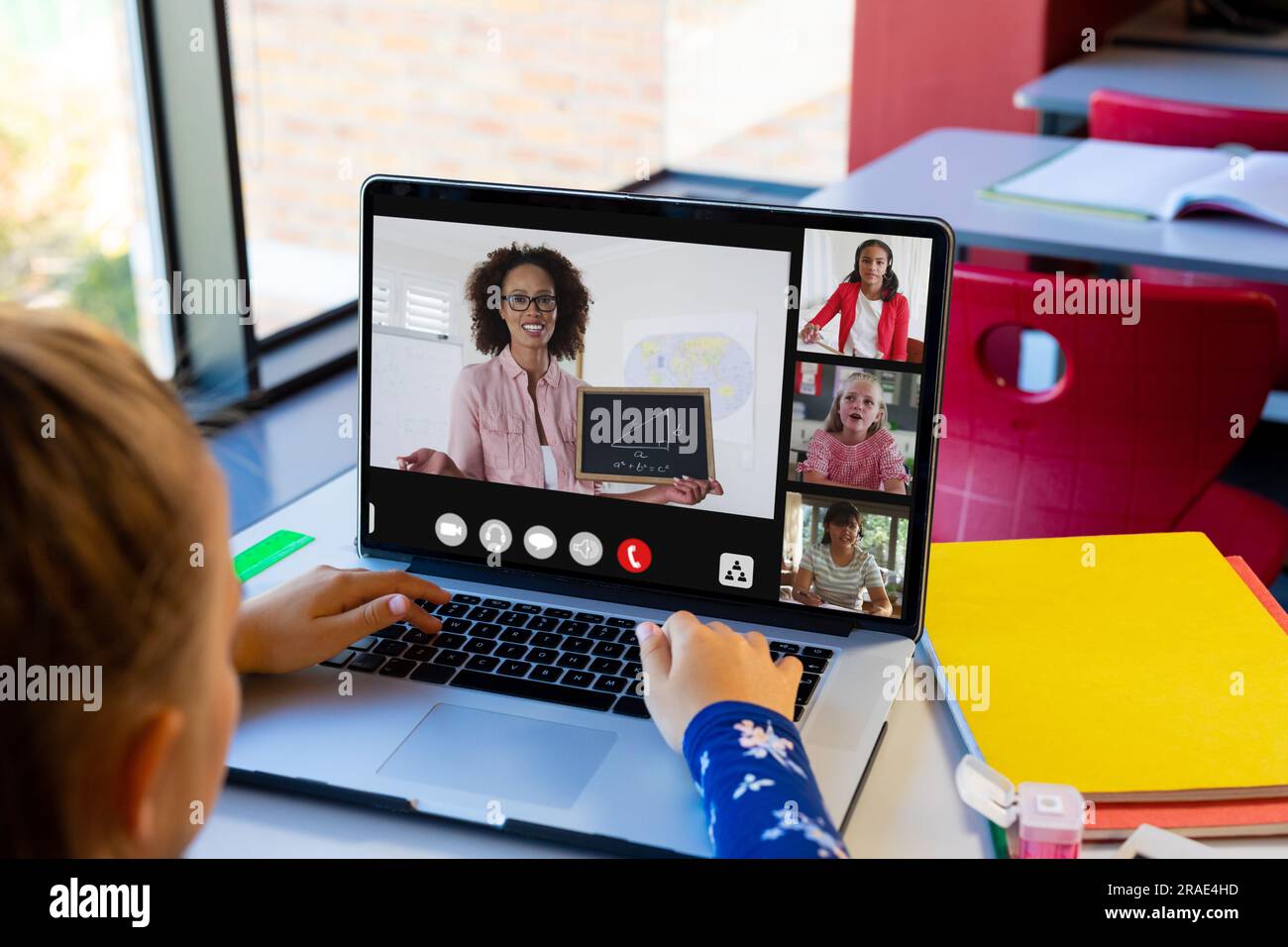 Diverse schoolchildren with female teacher having class during laptop ...