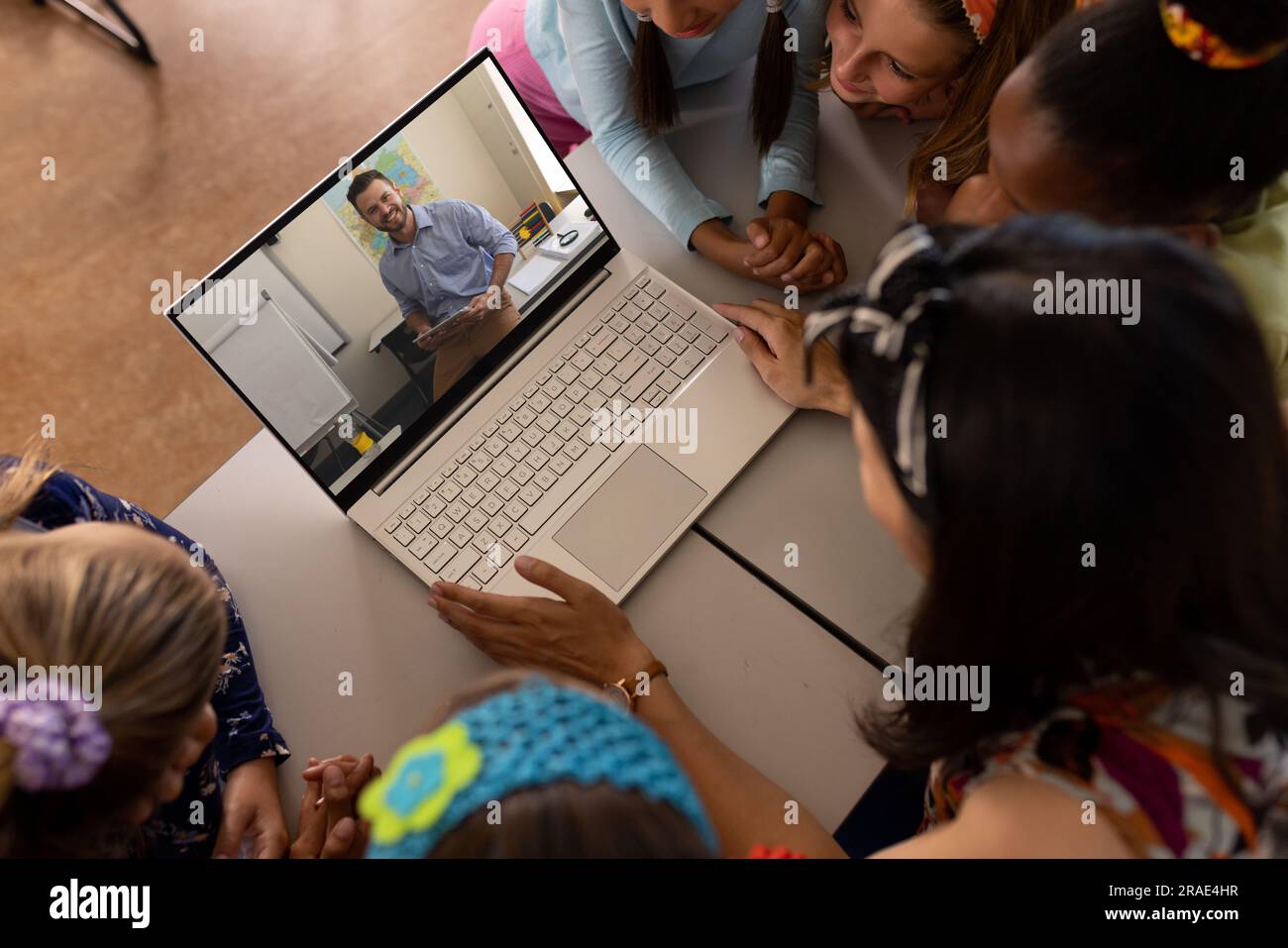 Diverse schoolchildren with teachers having laptop video call in ...