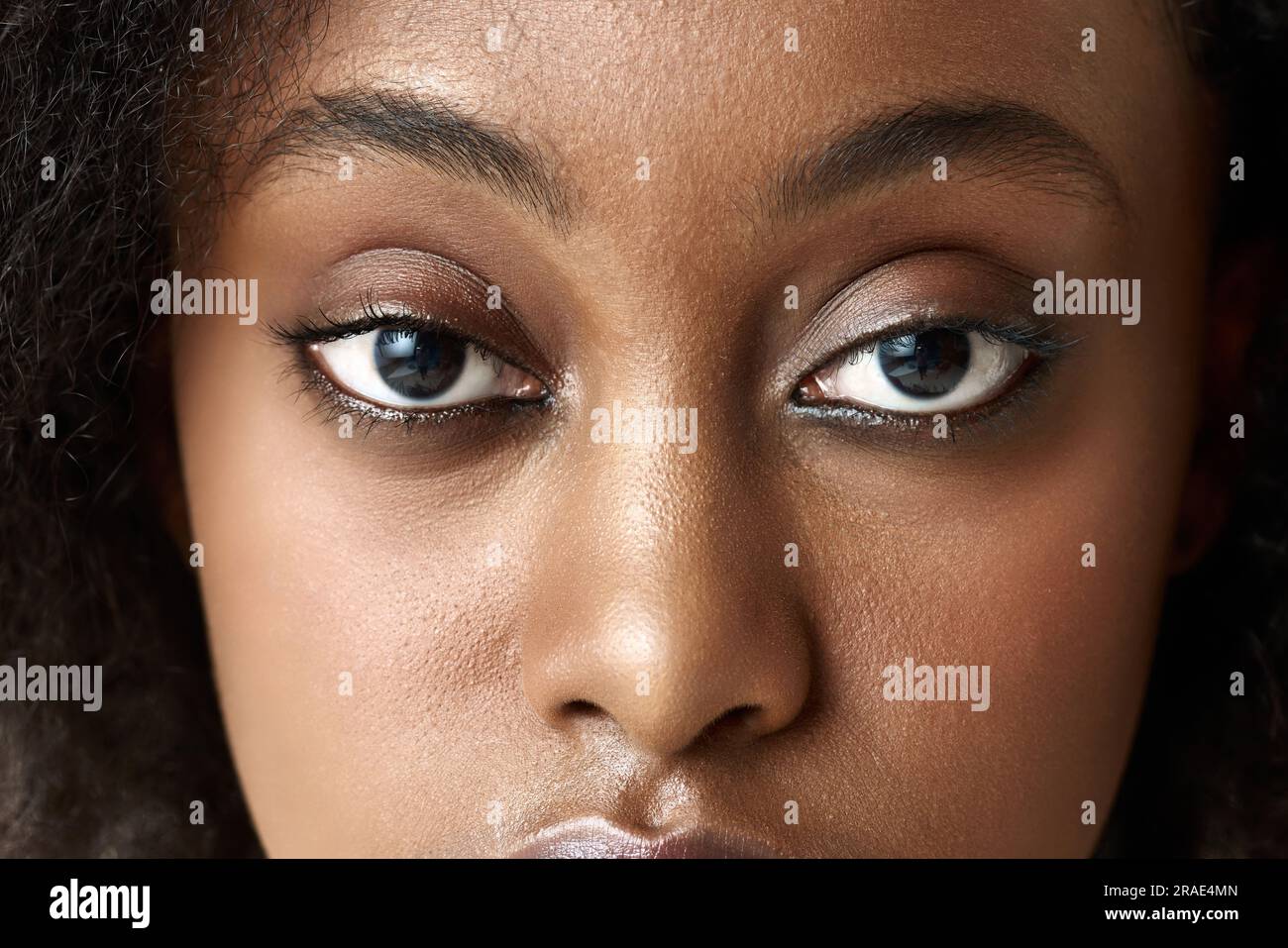 Close-up image of young african woman, eyes, nose. Model looking at ...