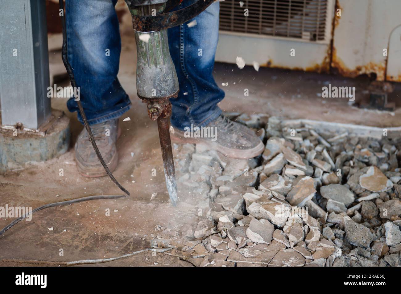 labor using a jackhammer to break up a concrete floor Stock Photo - Alamy