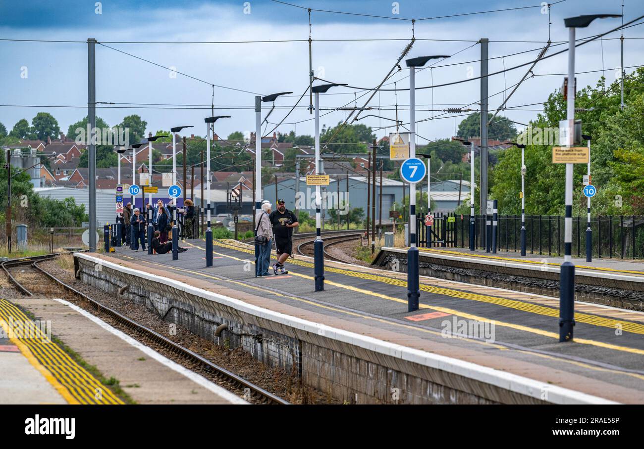 Passengers and travellers stood waiting for a train at Grantham Station ...