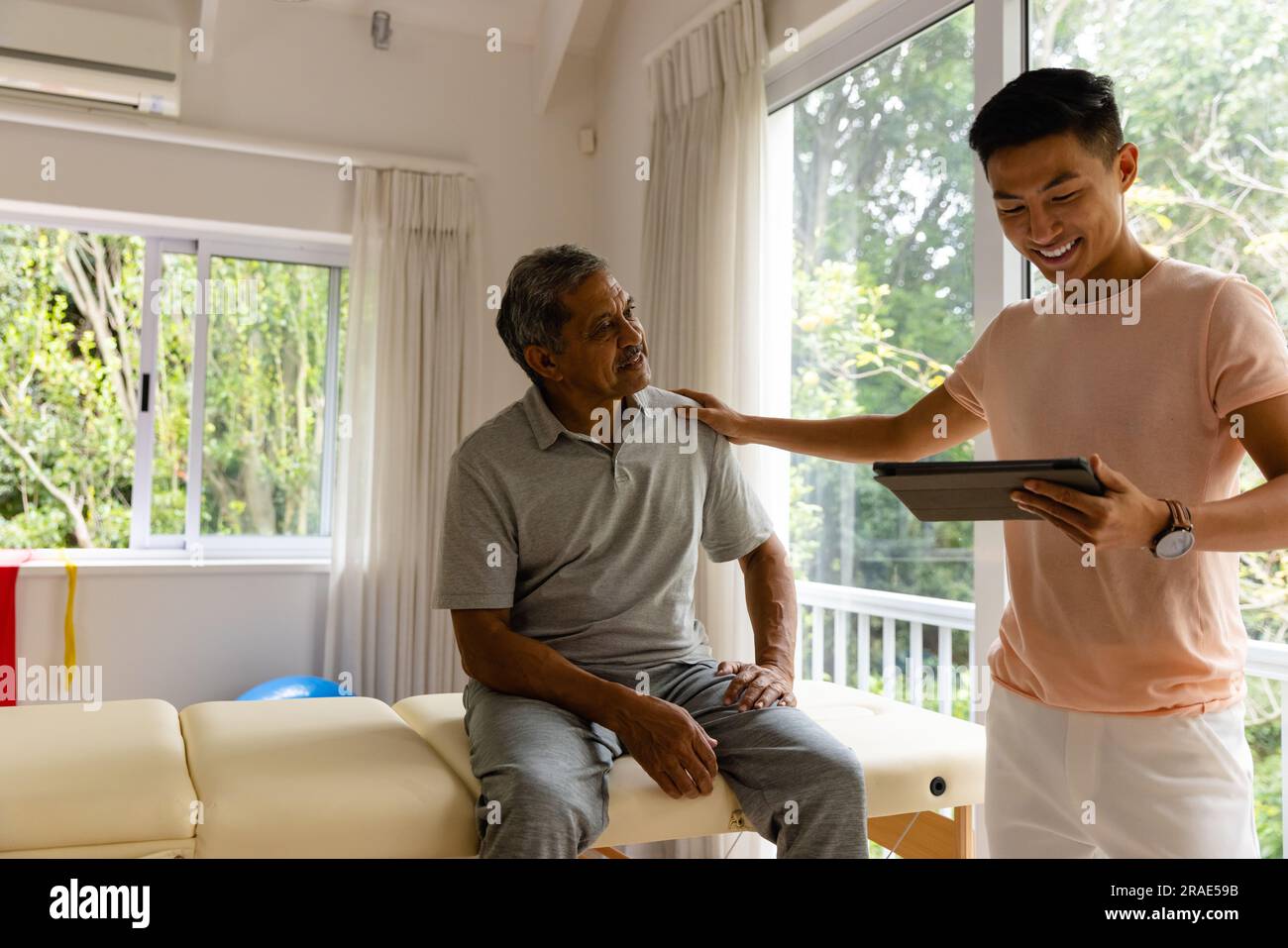 Happy diverse male physiotherapist hi-res stock photography and images ...