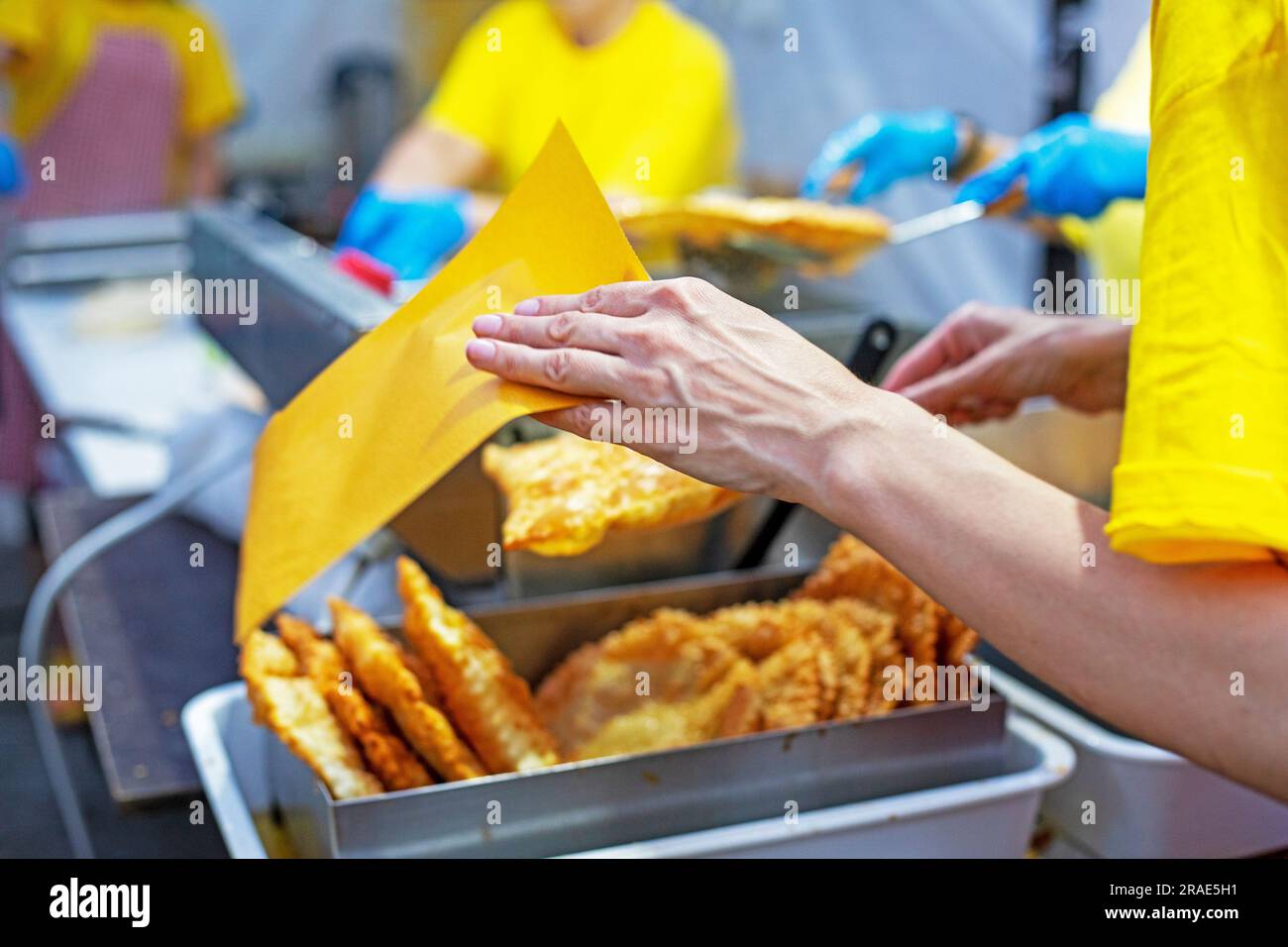 pack a delicious hot cheburek in edible yellow paper. Street food, food ...