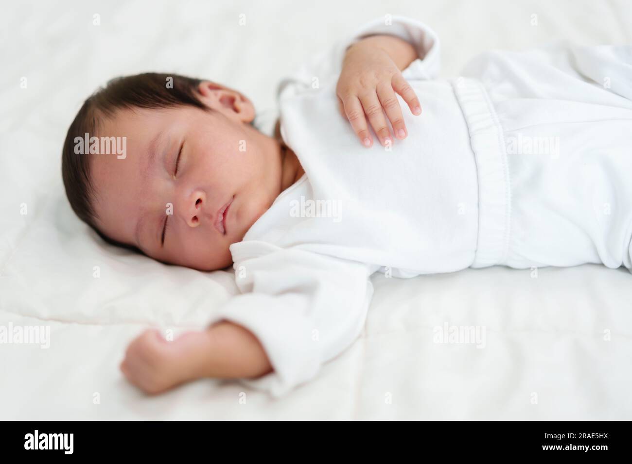 Black baby sleeping on bed hi-res stock photography and images - Alamy