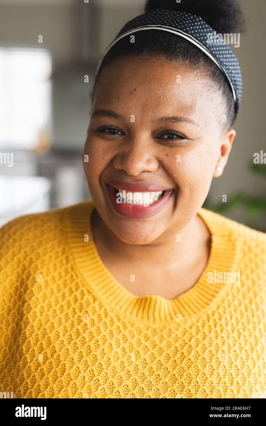 Portrait of happy african american woman wearing yellow sweater ...