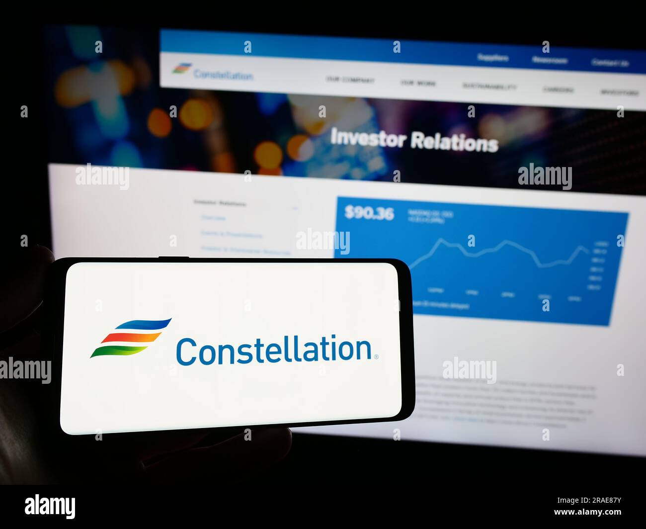 Person holding mobile phone with logo of American company Constellation ...