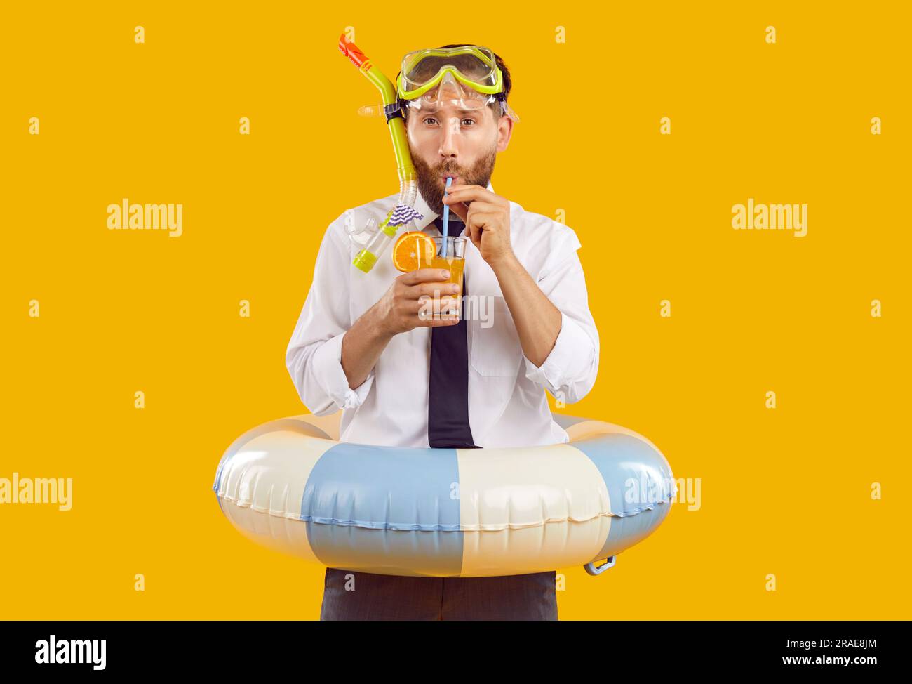 Funny office worker in shirt, snorkeling mask and beach ring drinking ...