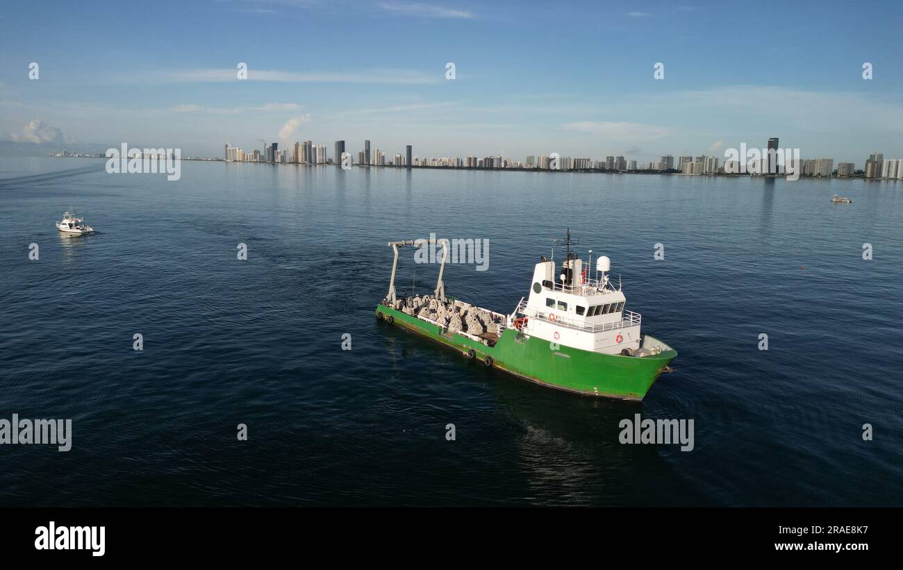 Aerial view of a cargo ship carrying artificial reef modules about to ...