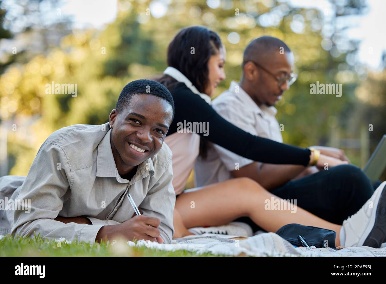 Black man, student and writing with group in study, project or ...