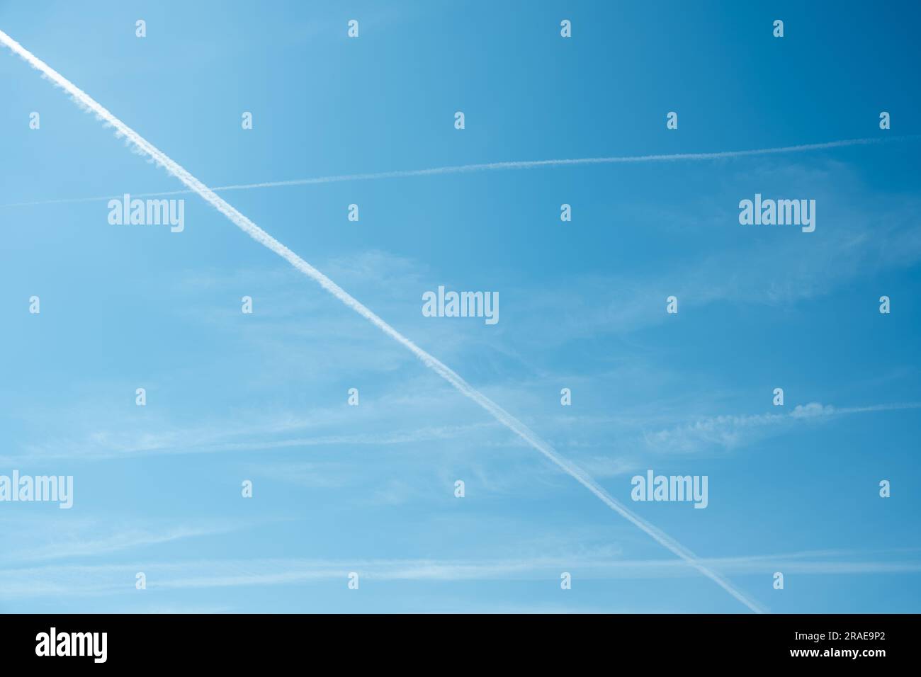 Jet plane contrails. Aircraft routes on blue sky. White airways traces ...