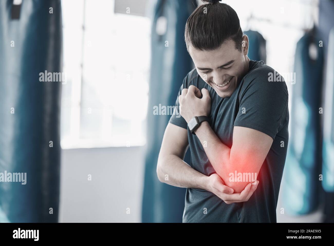 Hand, elbow pain and injury with the arm of a man in red highlight ...