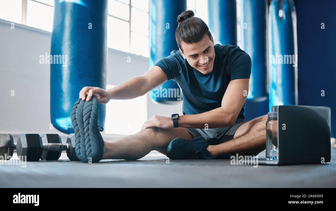 Stretching, fitness and a man with a laptop for exercise tutorial, information or a cardio video ...