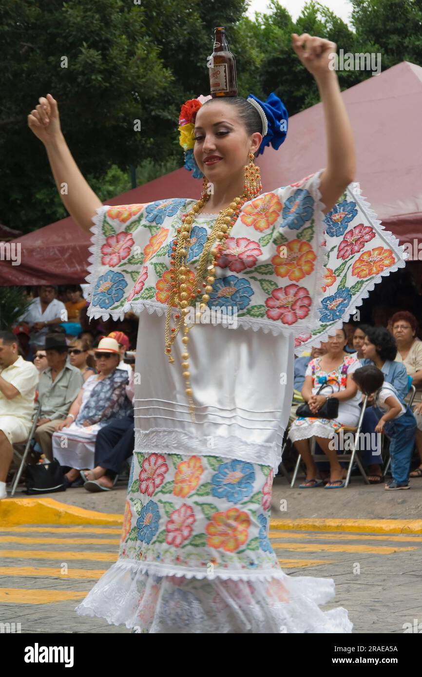 Dancer in traditional traditional costume, balancing bottle on head ...