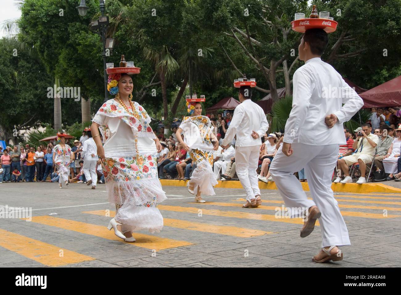 Dance group in traditional traditional costume, balancing trays on head ...