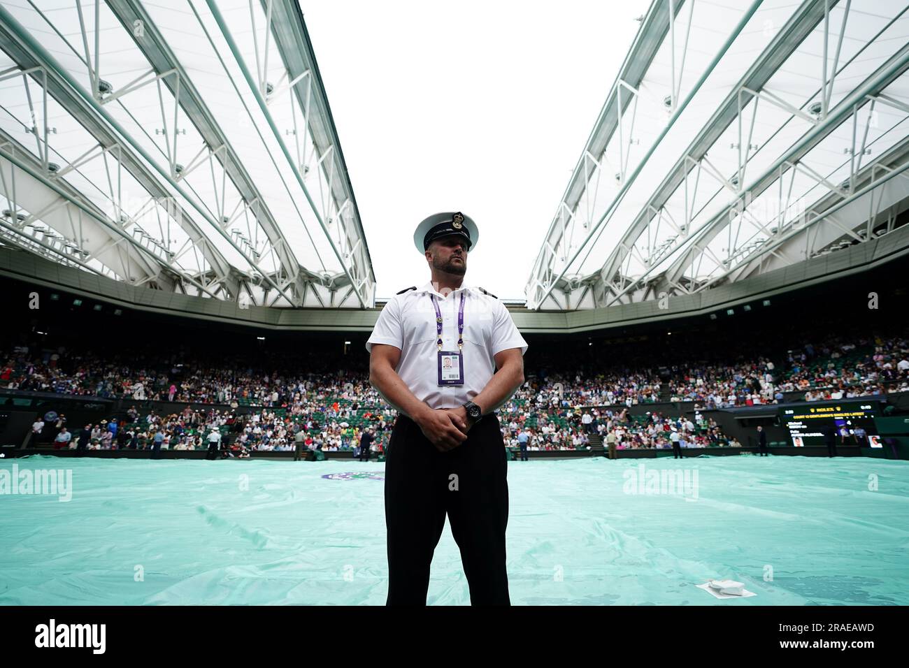 A member of the armed forces on centre court as the roof is closed on ...