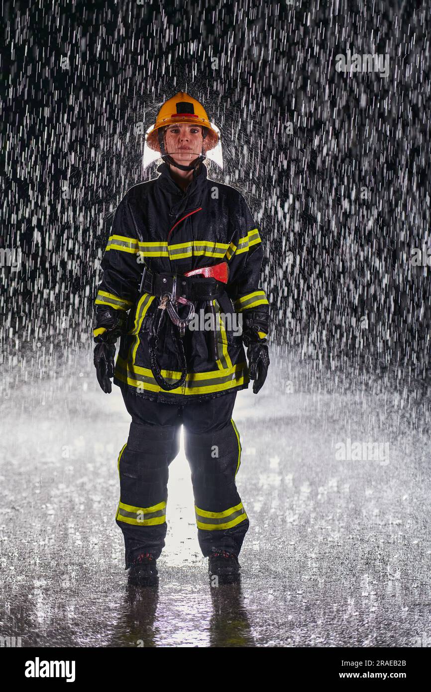 A determined female firefighter in a professional uniform striding ...