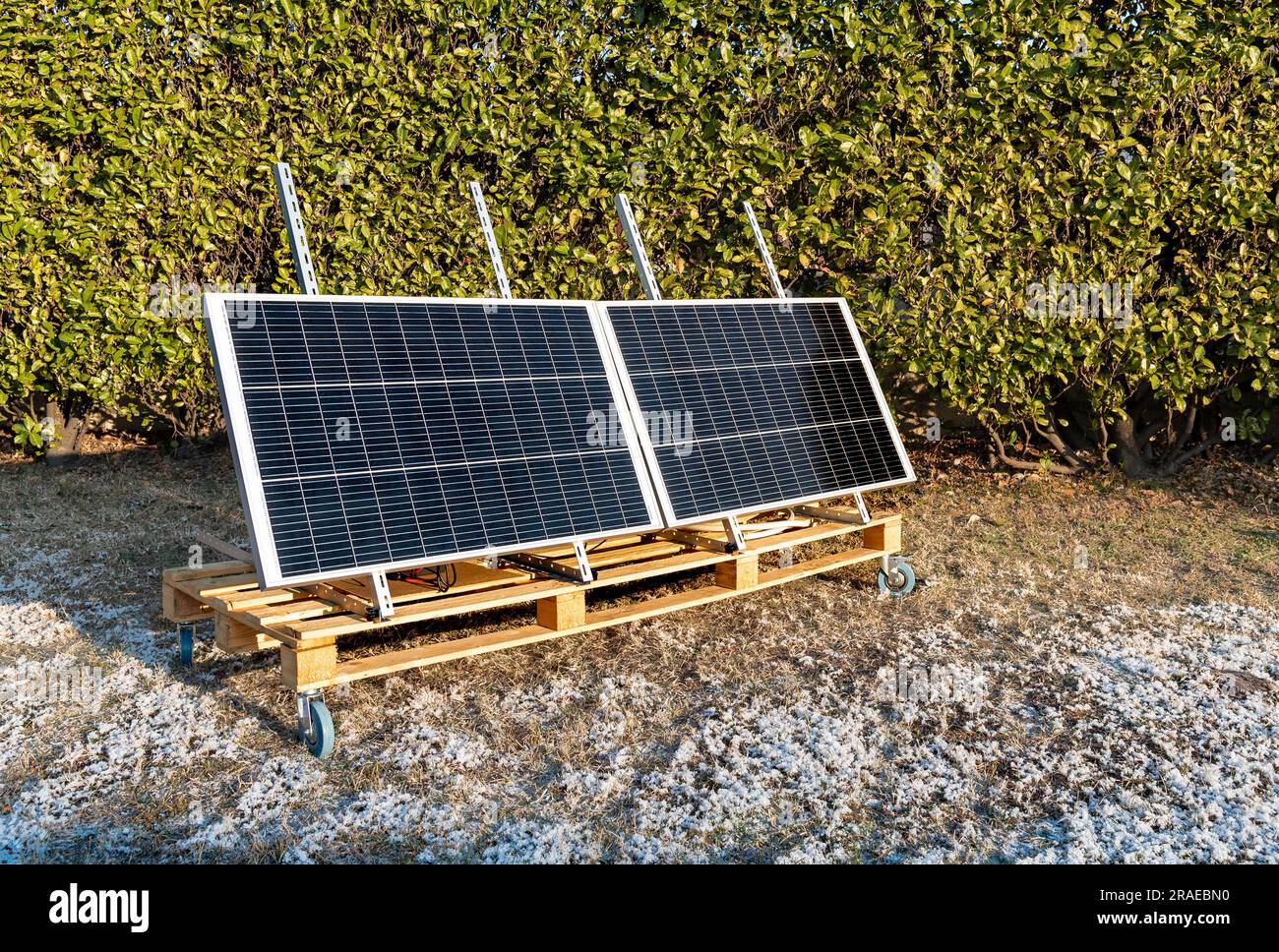 Photovoltaic panels on the wooden pallet in the home garden at winter ...